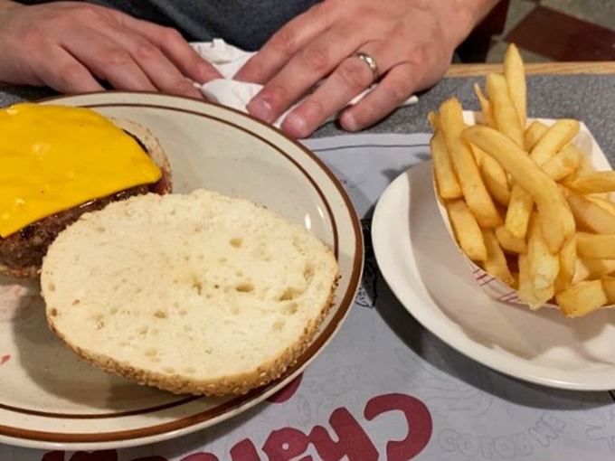 Simplicity at its finest: a golden cheese blanket tucked over a chargrilled patty, ready to meet its destiny with your taste buds.