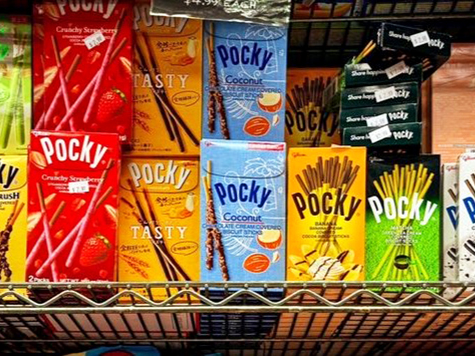 Pocky sticks stand at attention like delicious soldiers from Japan, their chocolate-dipped bodies and colorful packaging creating an edible art installation.