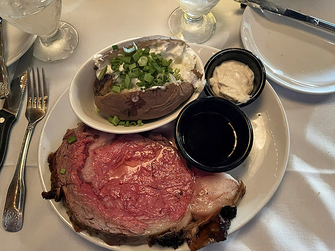 Prime rib so perfectly pink it could make a vegetarian reconsider their life choices. The loaded baked potato is just a bonus.