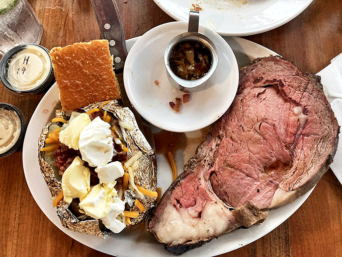 Prime rib so perfectly pink it should be illegal, served alongside a loaded baked potato that's practically begging to be devoured.