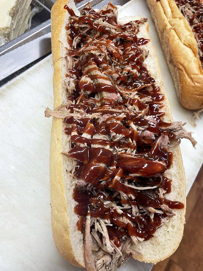 Pulled pork so tender it surrendered long ago, slathered in sauce that's hitting all the right notes. The bread's just trying to keep up.