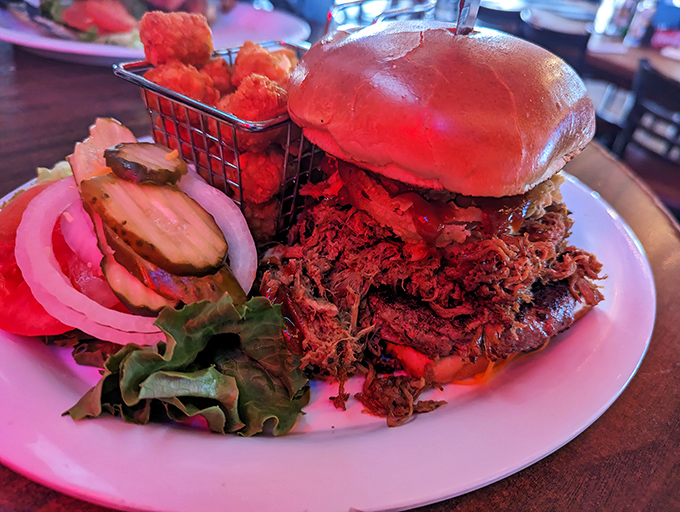 This isn't just a pulled pork sandwich&mdash;it's a monument to slow-cooked perfection, piled so high it requires strategic planning before the first bite.