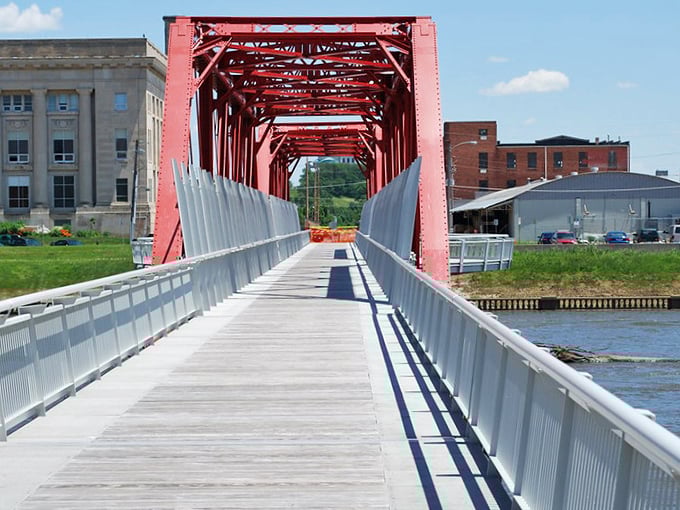 This crimson pedestrian bridge isn't just functional&mdash;it's a splash of architectural whimsy connecting Des Moines' practical past with its vibrant present.