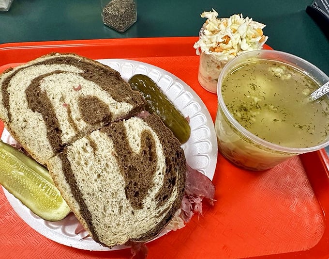 The perfect lunch trifecta: marbled rye sandwich, golden chicken soup, and coleslaw. The holy trinity of deli dining that soothes the soul and silences stomach grumbles.