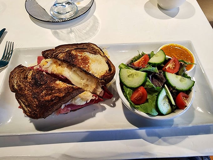 This isn't just a sandwich; it's a Reuben revelation with melty cheese cascading over perfectly grilled bread, accompanied by a garden-fresh salad.