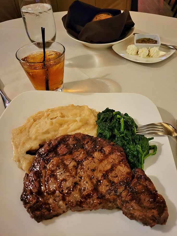 This rib eye steak doesn't just sit on the plate&mdash;it commands attention, flanked by mashed potatoes that whisper, "We're not just a side act."