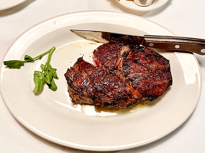 A ribeye with a crust so perfect it deserves its own Instagram account. The kind of steak that makes vegetarians nervously reconsider their life choices.