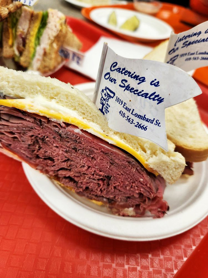 This isn't just a sandwich; it's a skyscraper of thinly-sliced roast beef that requires both hands, several napkins, and possibly a building permit.