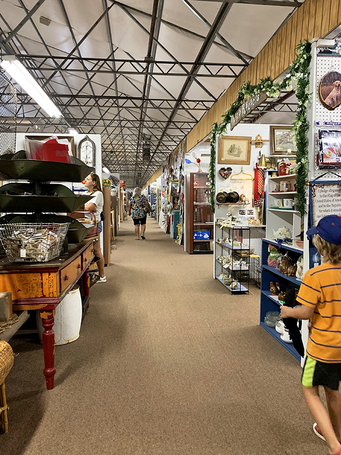 Treasures hide in plain sight along these endless aisles. The exposed ceiling trusses remind you this isn't your grandmother's cramped antique shop.