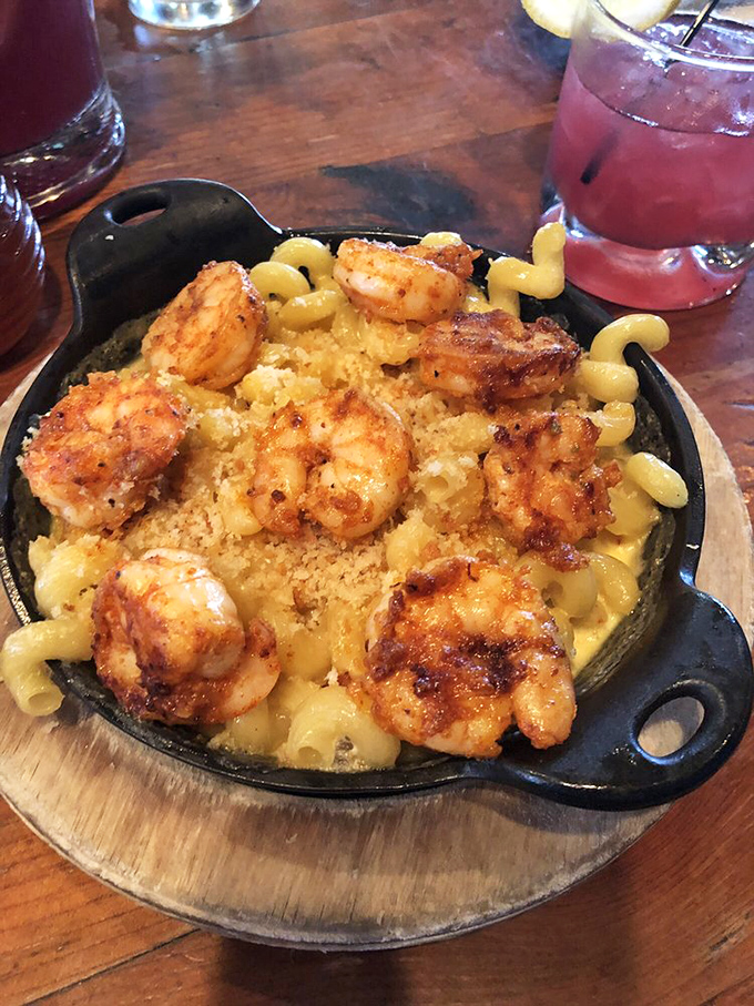 Plump shrimp lounging atop creamy mac and cheese like they're at a five-star resort. This isn't a side dish&mdash;it's the main event.
