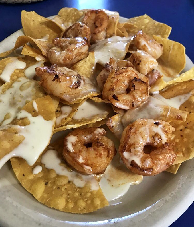 Shrimp nachos that could make a seafood skeptic weep with joy. These plump, perfectly grilled crustaceans lounging on cheesy chips are vacation on a plate.