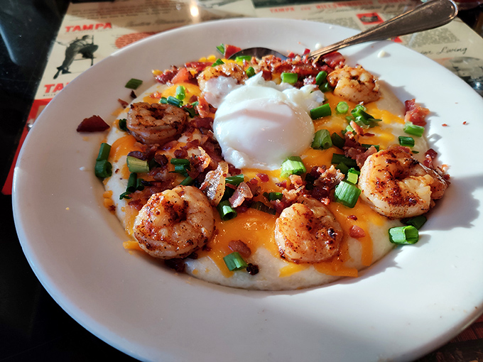 Southern comfort reimagined&mdash;creamy grits crowned with perfectly seasoned shrimp and a runny egg that creates the sauce nature intended.