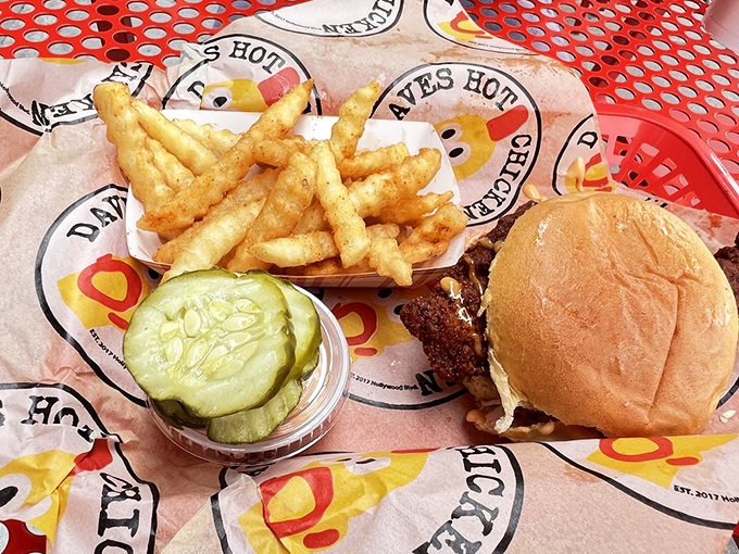 The slider arrives like a tiny ambassador of flavor, accompanied by golden fries and pickle slices that serve as the perfect palate cleansers.