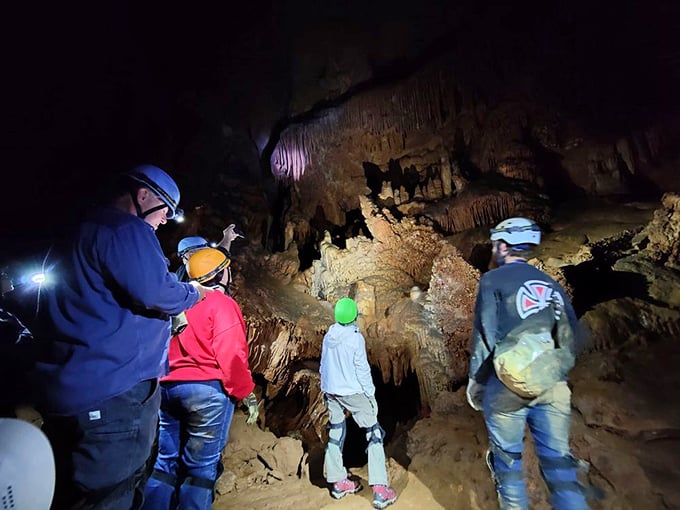 Modern-day explorers venture where few have gone, equipped with headlamps and wonder as they discover the cavern's hidden secrets.