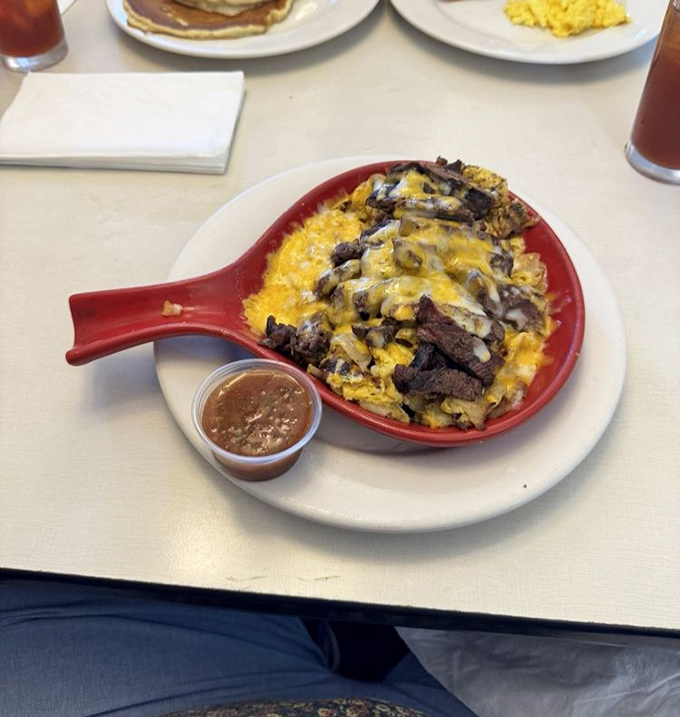 The legendary steak skillet in all its glory. Cheese cascading over perfectly seasoned beef&mdash;it's like a flavor volcano erupting on your taste buds.