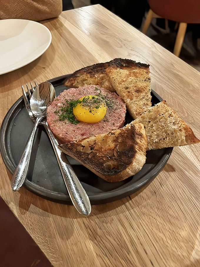 Steak tartare with golden yolk - raw perfection that requires both skill and courage to execute flawlessly.