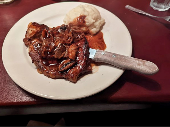 This pork chop with caramelized onions and mashed potatoes isn't just dinner&mdash;it's the kind of meal that makes you temporarily forget your own name.