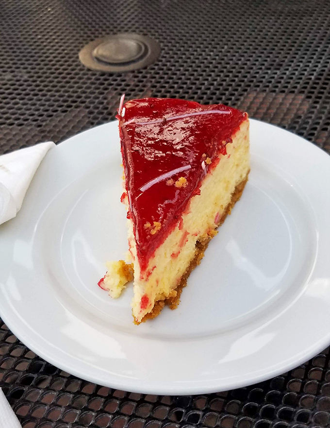 The strawberry cheesecake wears its ruby-red topping like a crown, with each bite delivering the perfect balance of sweet, tart, and creamy.