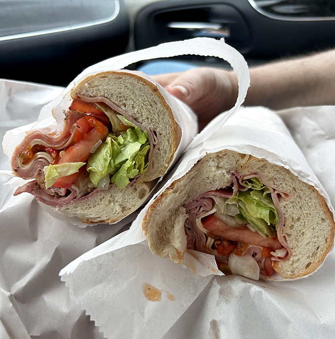 This Italian sub isn't just lunch; it's an architectural achievement of perfectly layered meats, veggies, and bread that demands to be photographed before devouring.