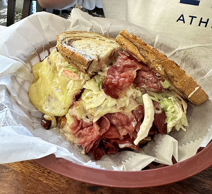 This isn't just lunch; it's architecture. Layers of corned beef and sauerkraut creating the Taj Mahal of sandwiches, with Swiss cheese as the mortar.