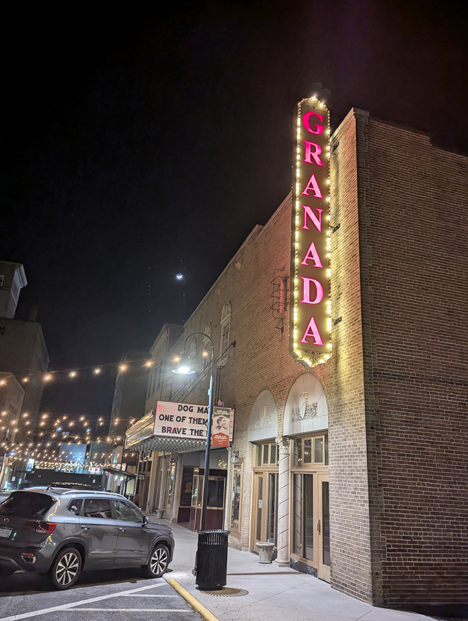 The Granada Theater's vintage neon sign illuminates downtown nights, offering entertainment that costs less than a movie in the big city.