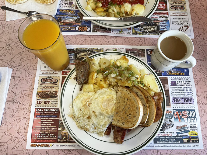 Sunny-side eggs, golden home fries, and perfectly browned sausage links—this plate is the breakfast equivalent of hitting the lottery on a Monday morning.