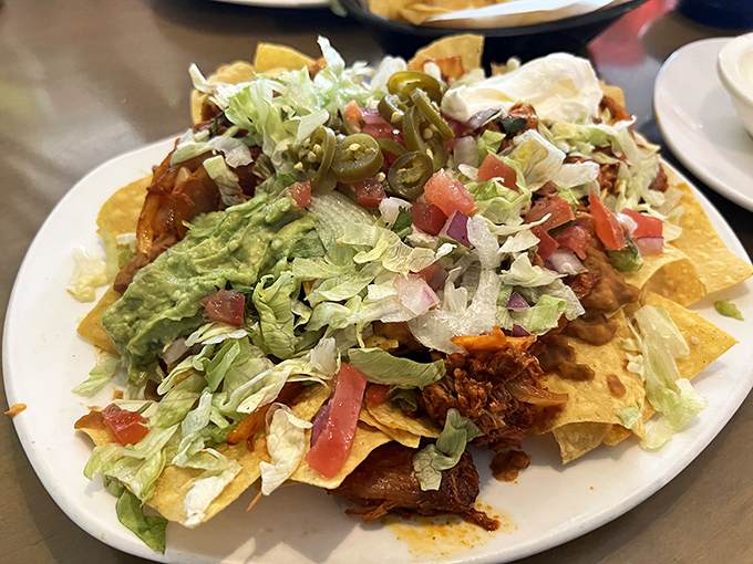Behold the nacho mountain! Each chip a carefully constructed platform for that perfect bite of tinga, guac, and jalape&ntilde;o bliss.