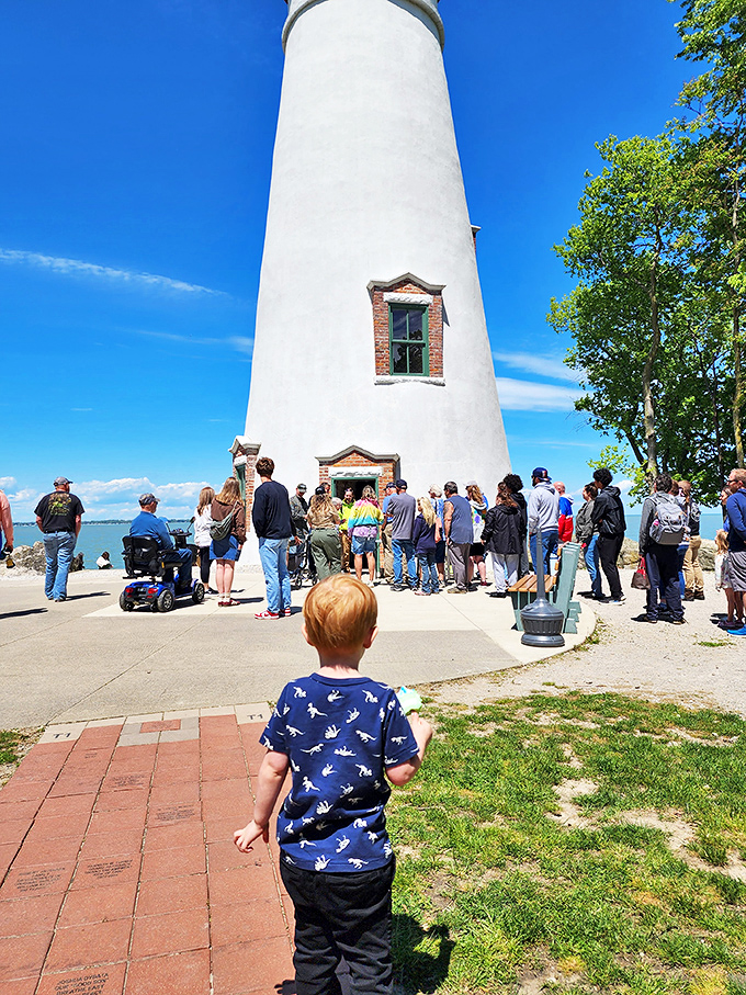 Lighthouse tours draw crowds eager to climb those 77 steps. That little one's probably wondering if there's a lighthouse keeper hiding inside.