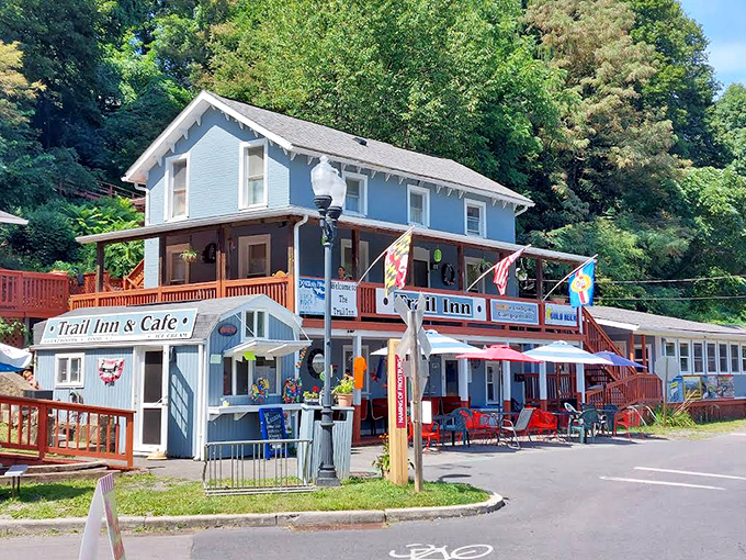 The Trail Inn & Cafe welcomes weary travelers with its cheerful blue exterior and promise of comfort food that makes you forget you were ever tired.