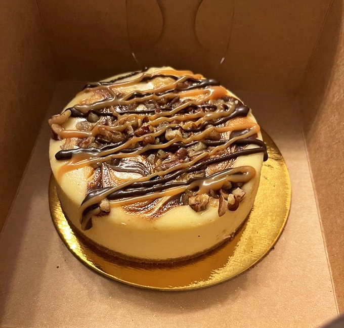 Turtle cheesecake reimagined: where caramel rivers flow over chocolate mountains and pecan boulders create a landscape too beautiful to resist.