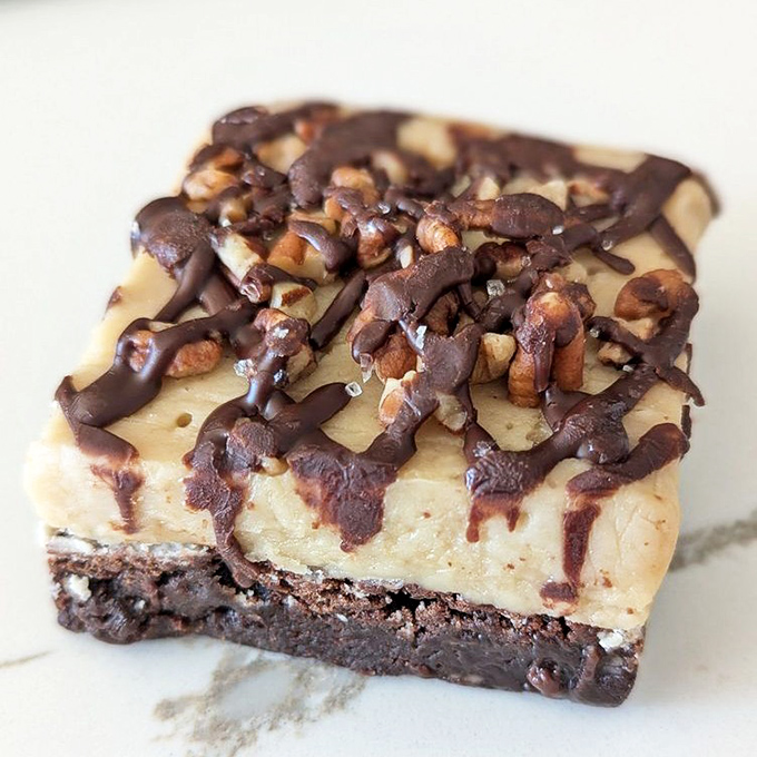 Turtle brownie or architectural masterpiece? Layers of chocolate, caramel, and pecans creating what can only be described as the Taj Mahal of handheld desserts.