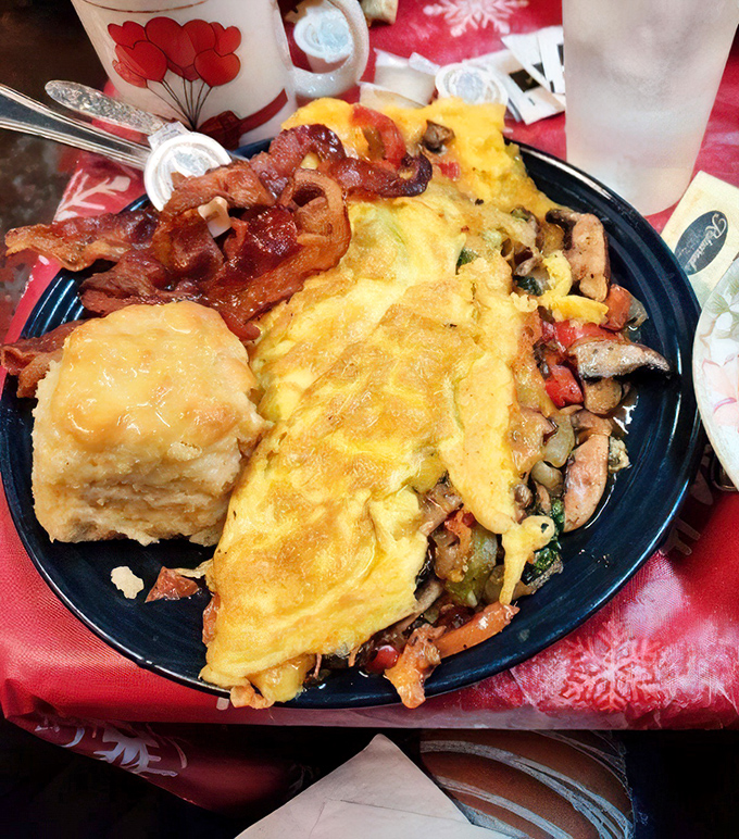 This isn't just breakfast&mdash;it's edible architecture. The omelet practically glows, stuffed with vegetables and paired with a biscuit that deserves its own fan club.