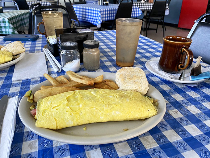 This omelet doesn't need a fancy French name to prove its worth—just look at that golden perfection alongside a biscuit that means business.