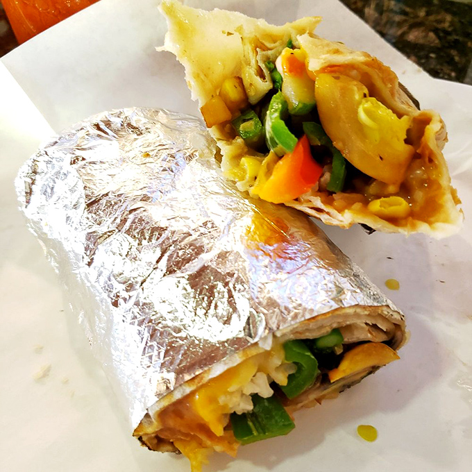 Peek inside this veggie burrito and discover a colorful neighborhood of peppers, rice, and beans living in perfect harmony.