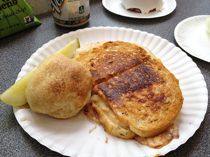 A sandwich so good it deserves its own plate pattern. That golden-brown rye bread is the frame for a masterpiece of melted cheese and savory fillings.