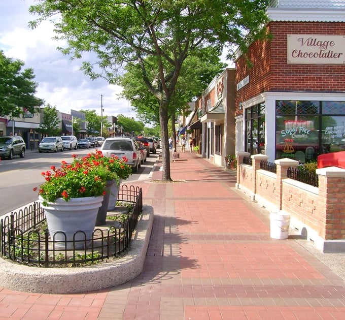 Village Chocolatier anchors the corner with sweet promises. The brick sidewalks practically guide your feet right to the door.