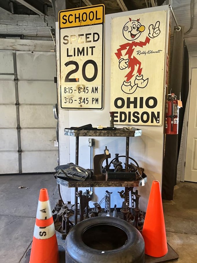 Reddy Kilowatt grins alongside vintage road signs, silently judging our smartphone-dependent navigation skills. Remember when we memorized directions?