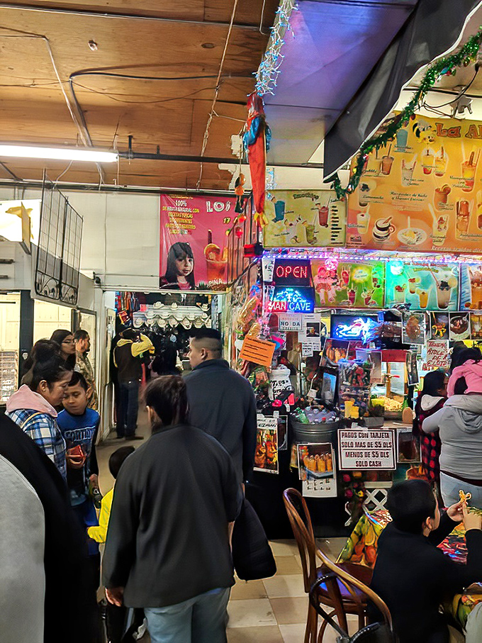 Weekend crowds navigate the marketplace's bustling corridors, where neon signs and festive decorations create the atmosphere of a permanent fiesta.