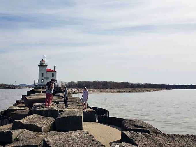 The half-mile journey becomes a pilgrimage of sorts, with fellow lighthouse enthusiasts making their way across Lake Erie's concrete peninsula.