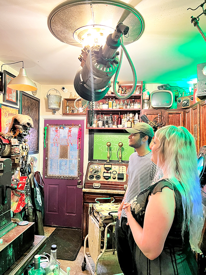 Bathed in an eerie green glow, visitors marvel at ceiling-mounted contraptions while surrounded by curios that would make Tim Burton feel right at home.