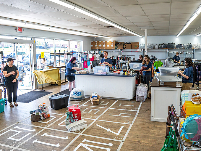 The checkout area buzzes with activity as staff process an endless stream of treasures. Like archaeologists of fashion, they carefully examine each potential addition.