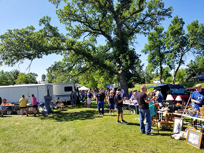 Community in action. Beneath the canopy of ancient oaks, shoppers and sellers create a temporary village united by the thrill of the unexpected find.