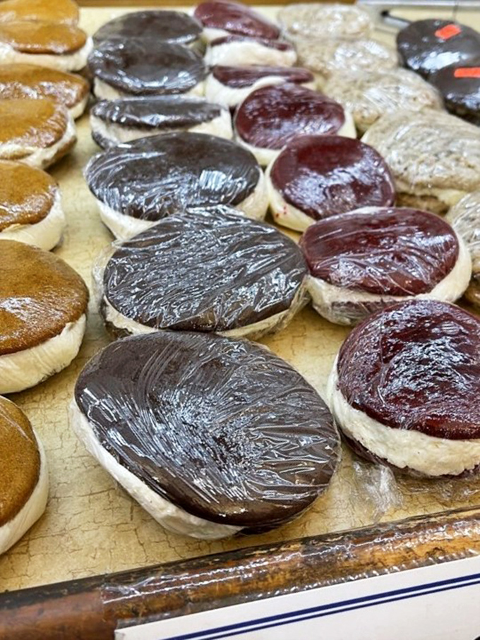 Whoopie pies lined up like sweet soldiers, each one a perfect sandwich of cake and cream that puts your childhood snack cakes to shame.