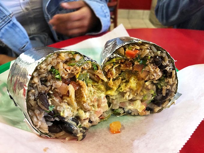 Behold the cross-section of burrito perfection! Like geological strata of deliciousness, each layer tells a story of flavor, texture, and culinary mastery.