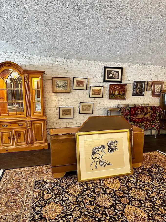 Furniture time travel at its finest. That floral-patterned couch has seen things, while the wooden dresser holds secrets from another era entirely. 