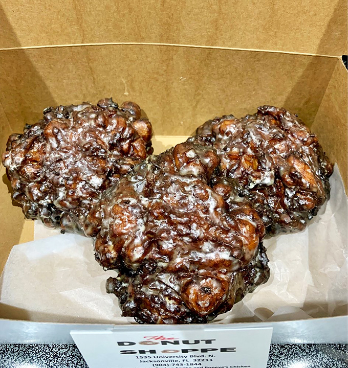 These apple fritters aren't just donuts—they're edible sculptures, with craggy peaks and valleys of cinnamon-spiced glory waiting to be conquered.