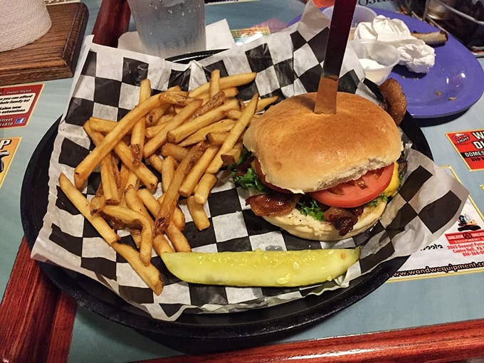 This isn't just a burger and fries&mdash;it's comfort on a checkered paper, with that pickle spear standing guard like it knows something special is happening.