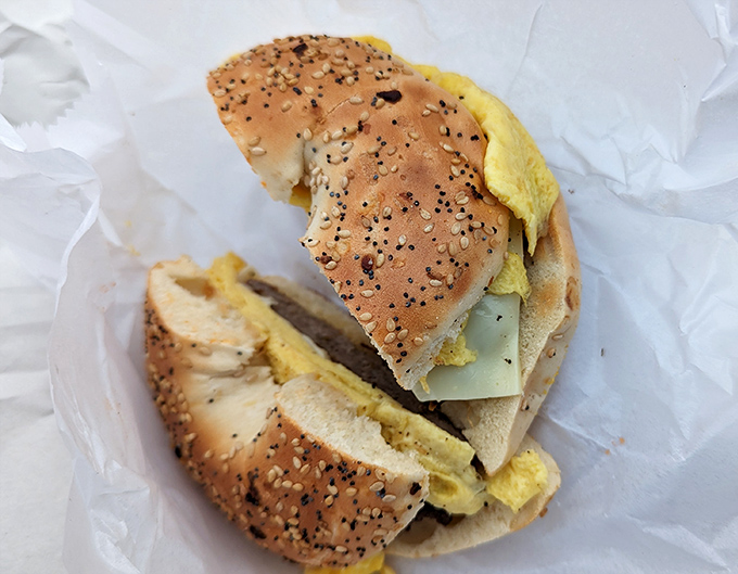 Breakfast sandwich nirvana on a seeded bagel &ndash; eggs, meat, and cheese coming together like the world's most delicious morning rock band.