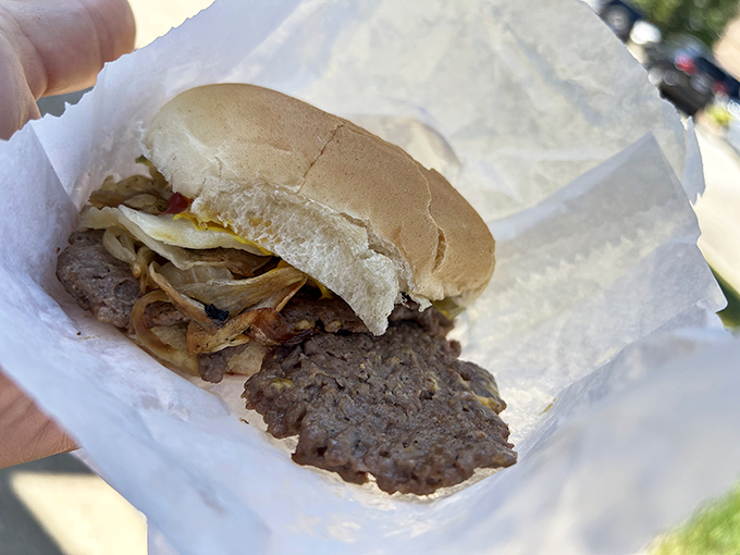 Beauty in simplicity—a perfectly grilled patty with caramelized onions on a toasted bun, no pretension, just pure burger satisfaction.