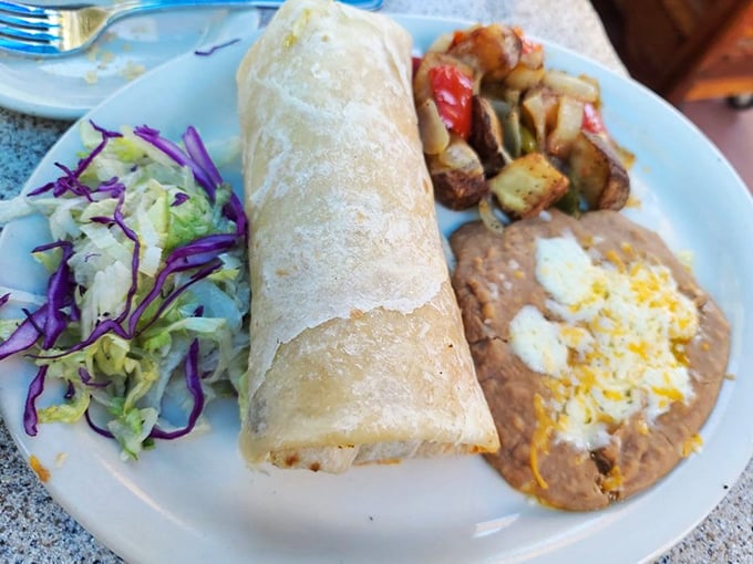 Behold the burrito in its natural habitat&mdash;plump, perfectly rolled, and flanked by refried beans that have clearly been given the respect they deserve.